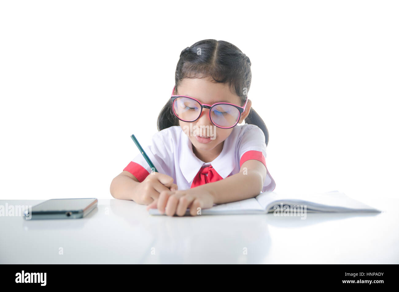 Asian little girl doing homework in Thai Student uniform isolated on ...