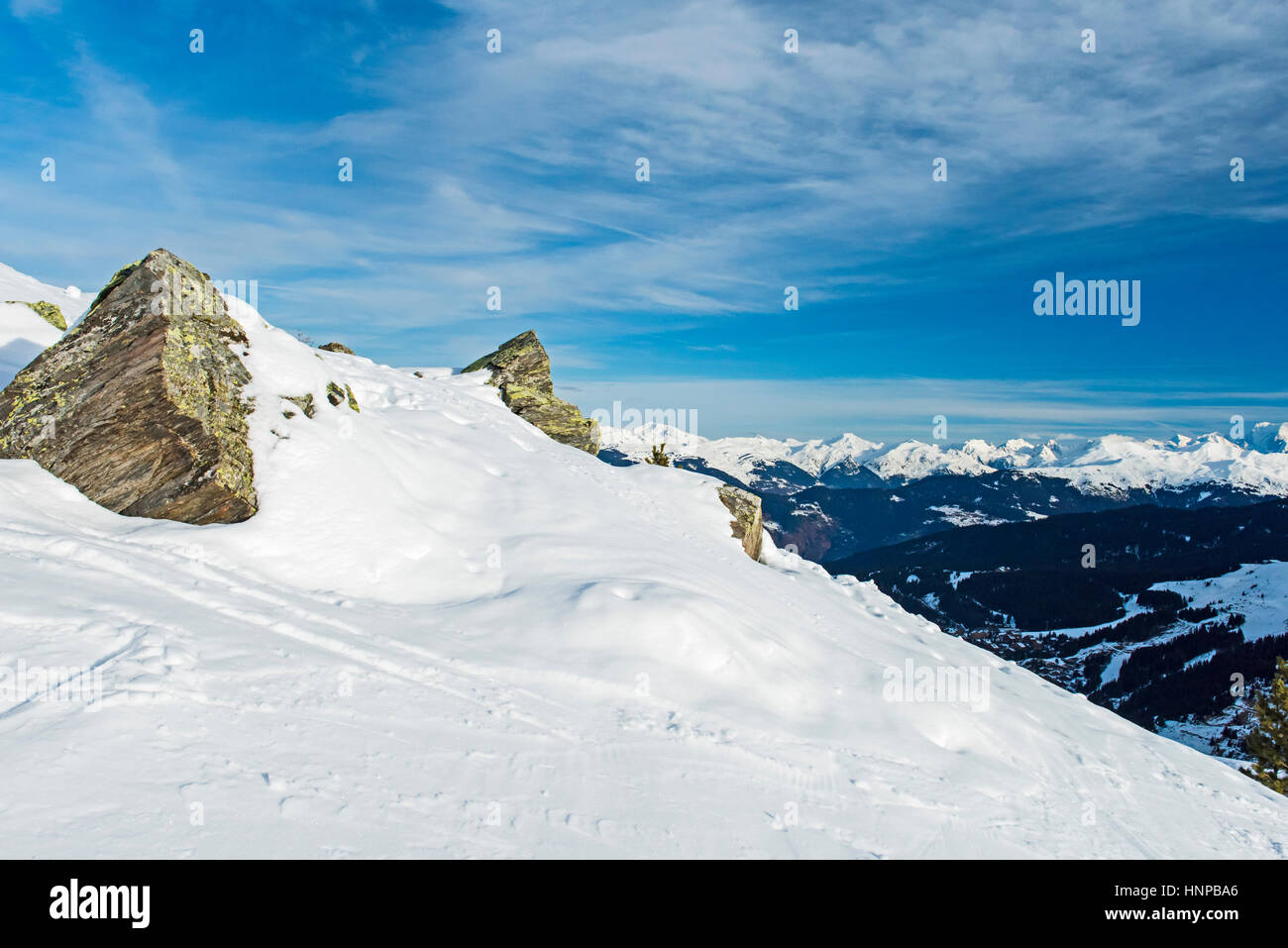 Panoramic view down valley of a snow covered alpine mountain range in ...