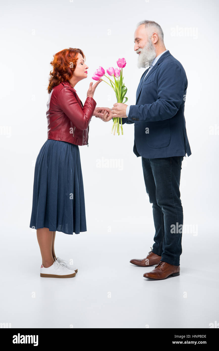 Man presenting flowers to woman Stock Photo - Alamy