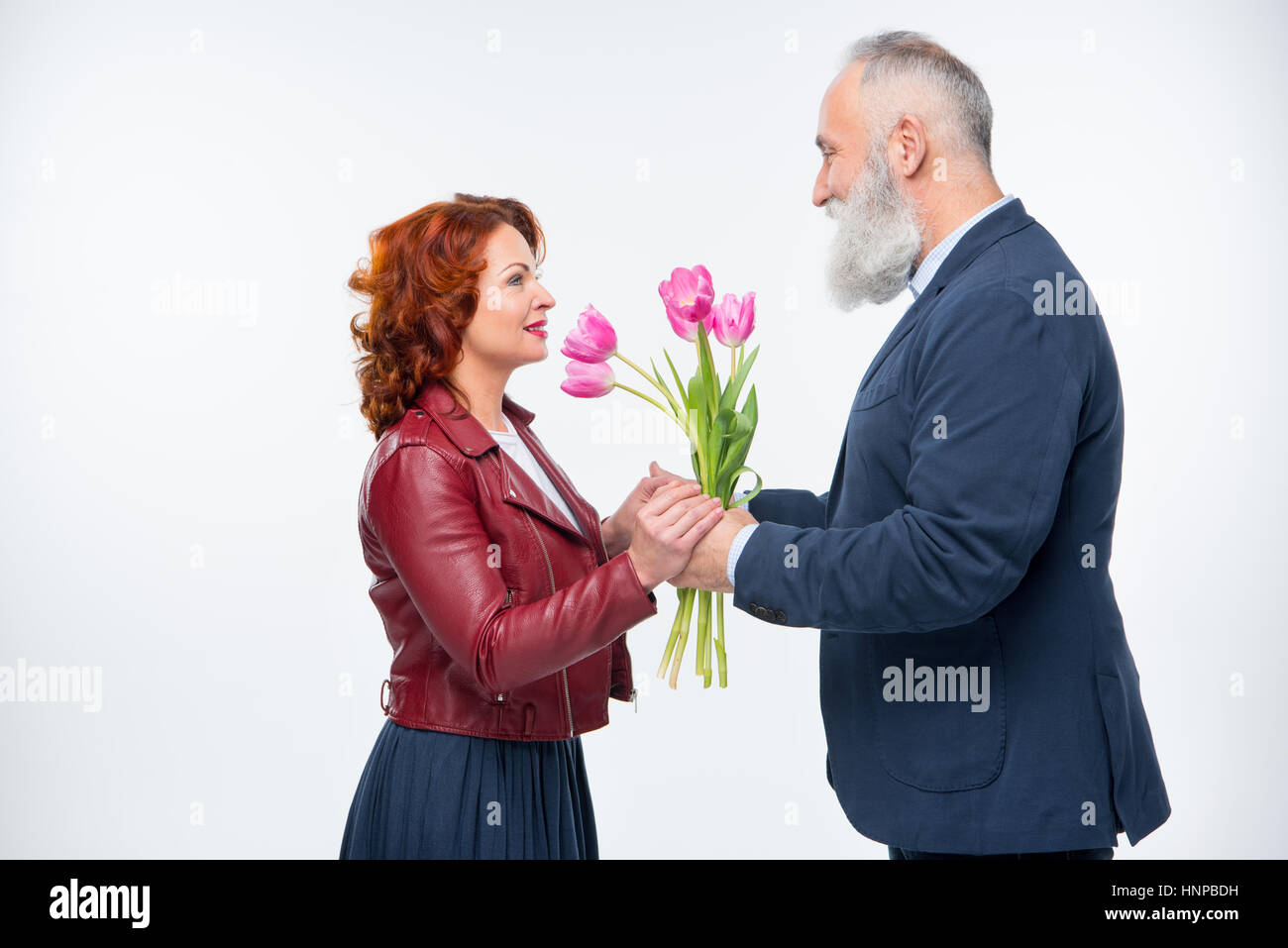 Man presenting flowers to woman Stock Photo - Alamy