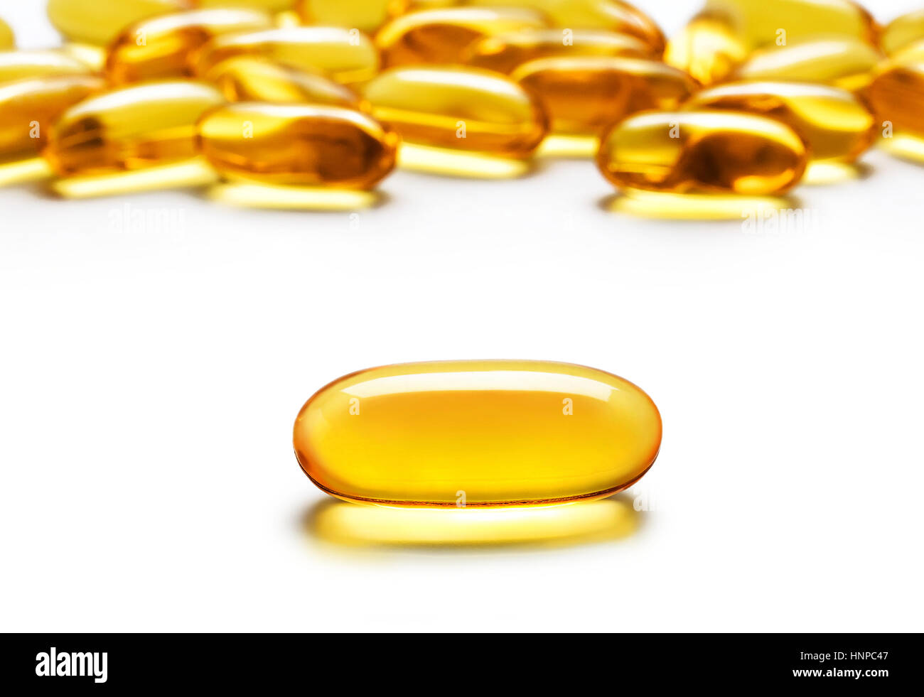 Close up one capsule Omega 3 and many other of capsules isolated on ...