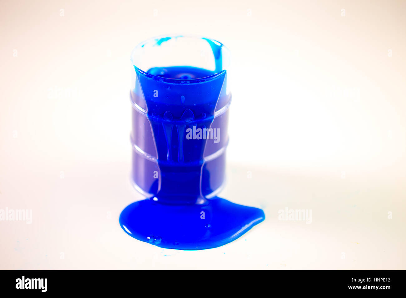 Blue slime spllling over side of barrel on white background Stock Photo ...