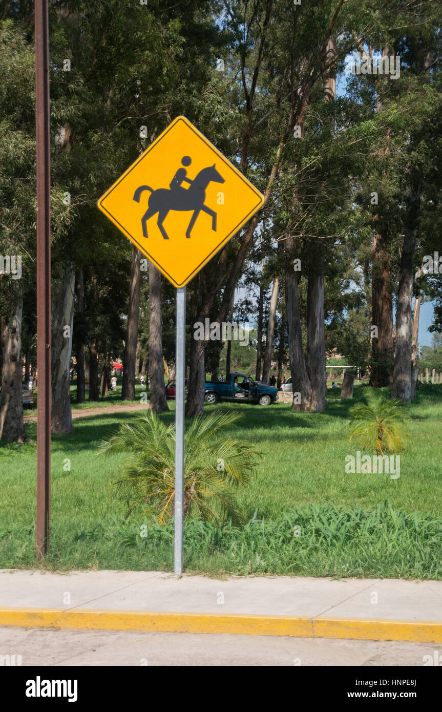 A urban sign of people riding horses crossing Stock Photo - Alamy