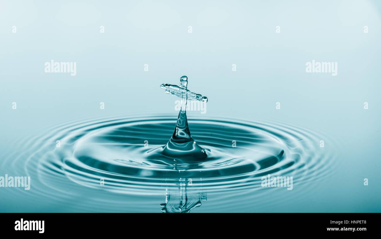 Water drop falling and drips on water mirror. Water drop splash and ...