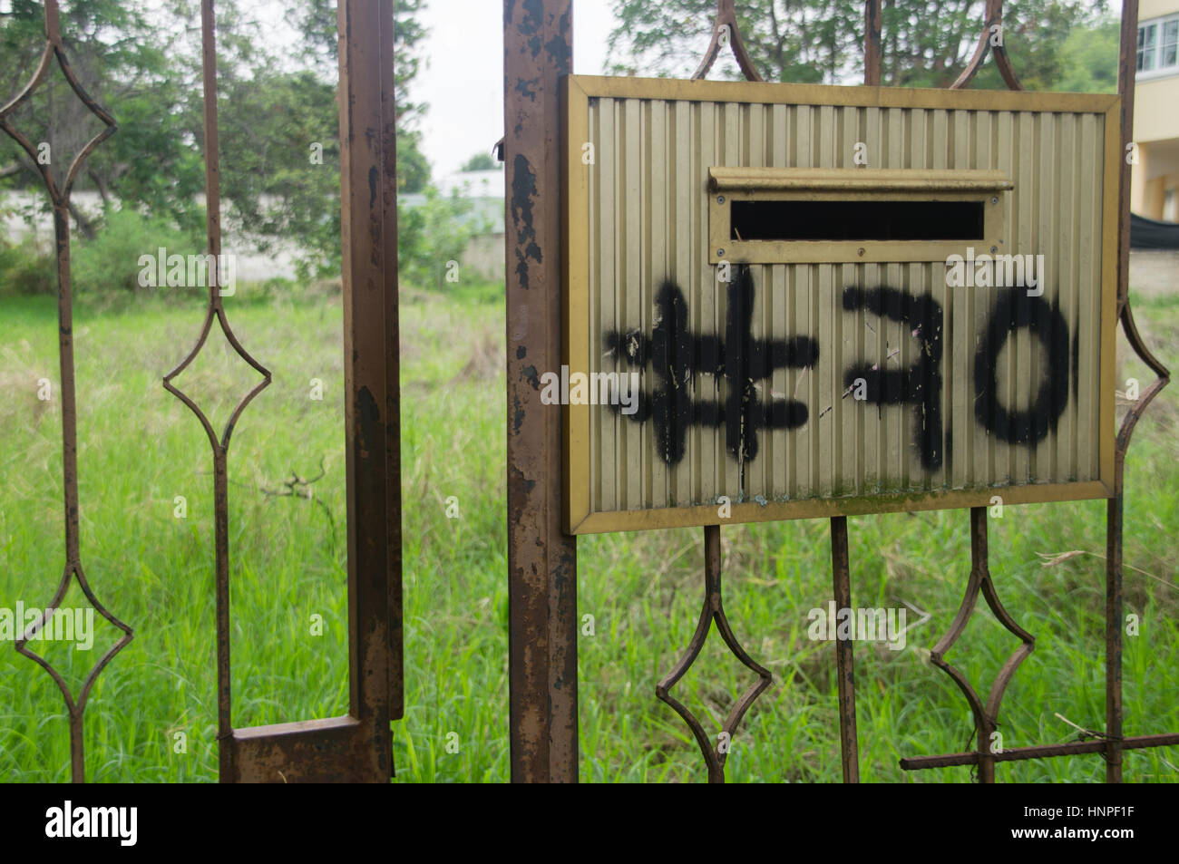 An open gate of an empty city lot Stock Photo - Alamy