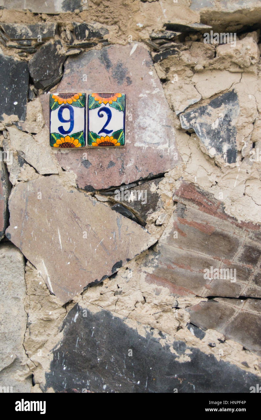 Two decoratives tiles depicting the number ninety two over a wall Stock ...