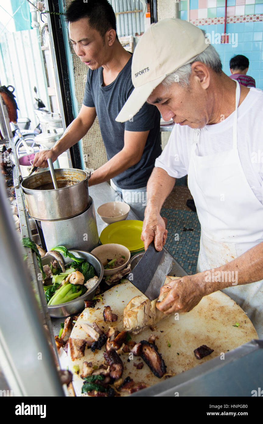 Chefs chopping up chicken, coffee shop, Georgetown, Penang, Malaysia ...