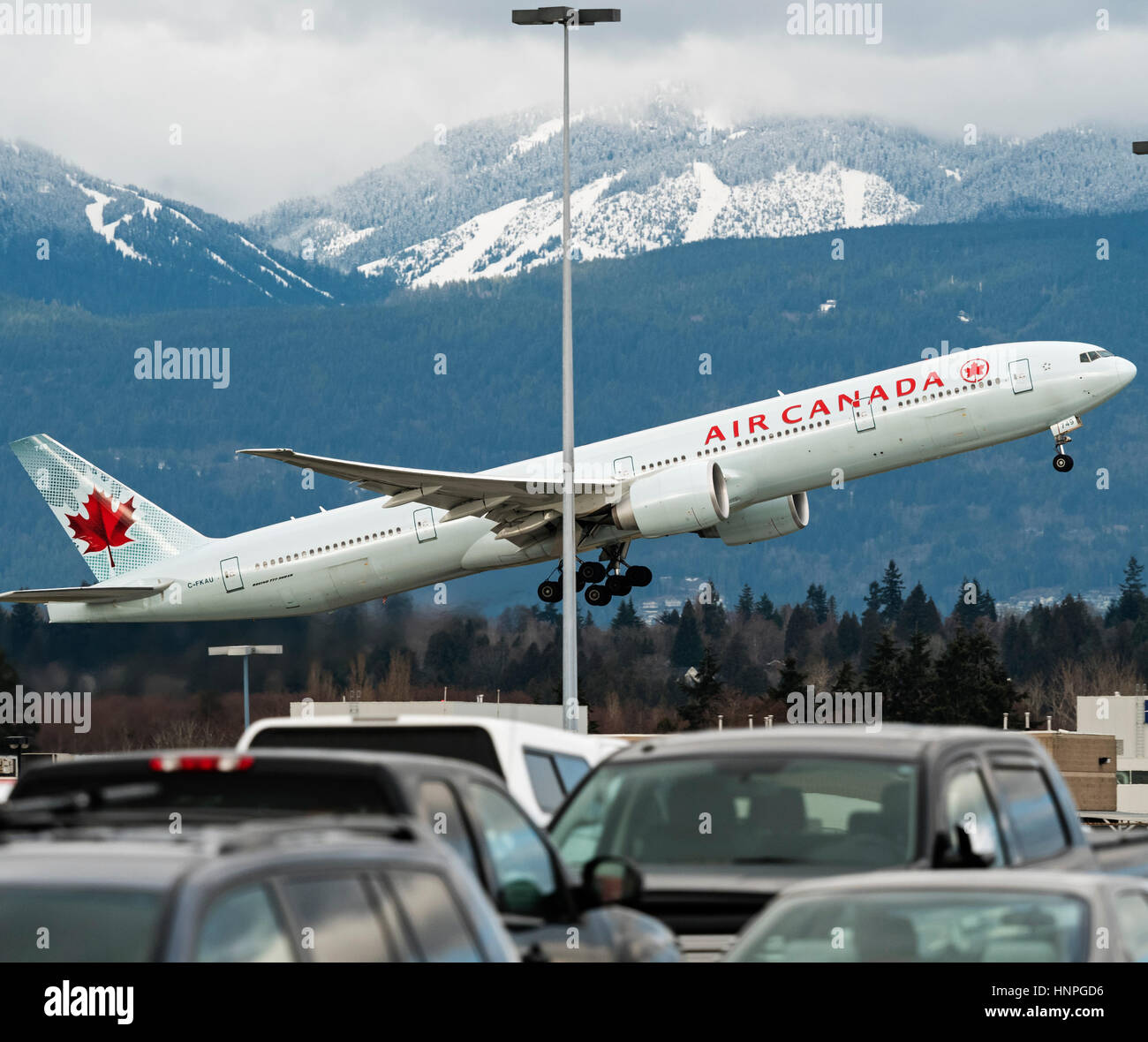 Air Canada plane Boeing 777 (777-300ER) taking off behind a Vancouver ...