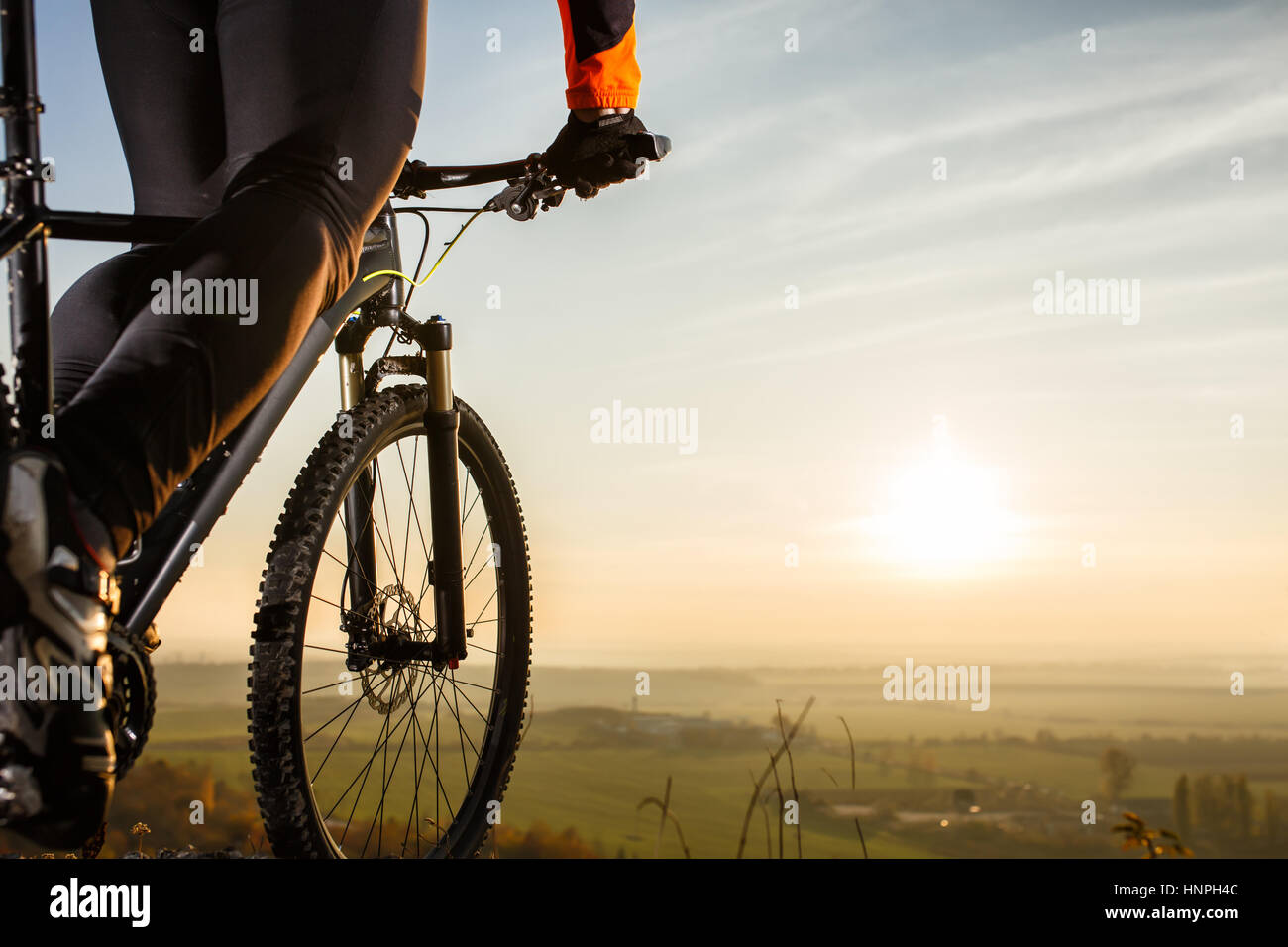 Close-up view on a cyclist. Biker riding a bike on the way view from ...