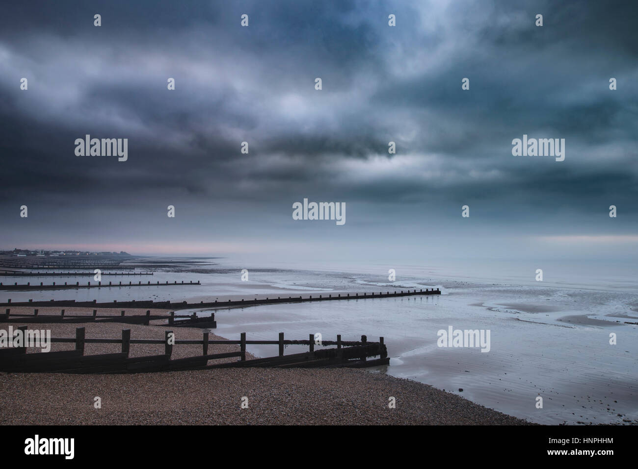 Cold Winter beach sunrise landscape at low tide with moody sky Stock ...