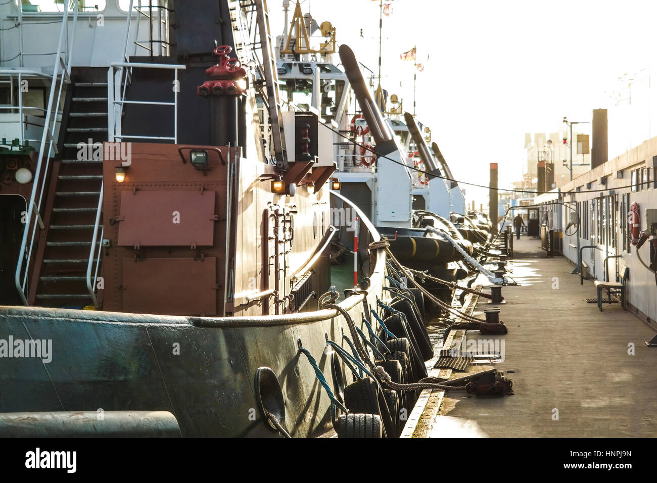 pilot tug boats vessels moored at jetty in harbor Stock Photo - Alamy