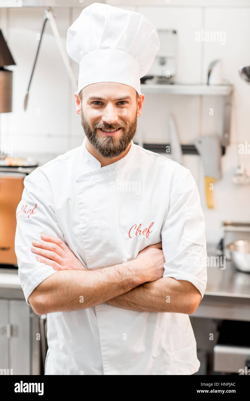 Portrait of chef cook in uniform at the restaurant kitchen Stock Photo ...