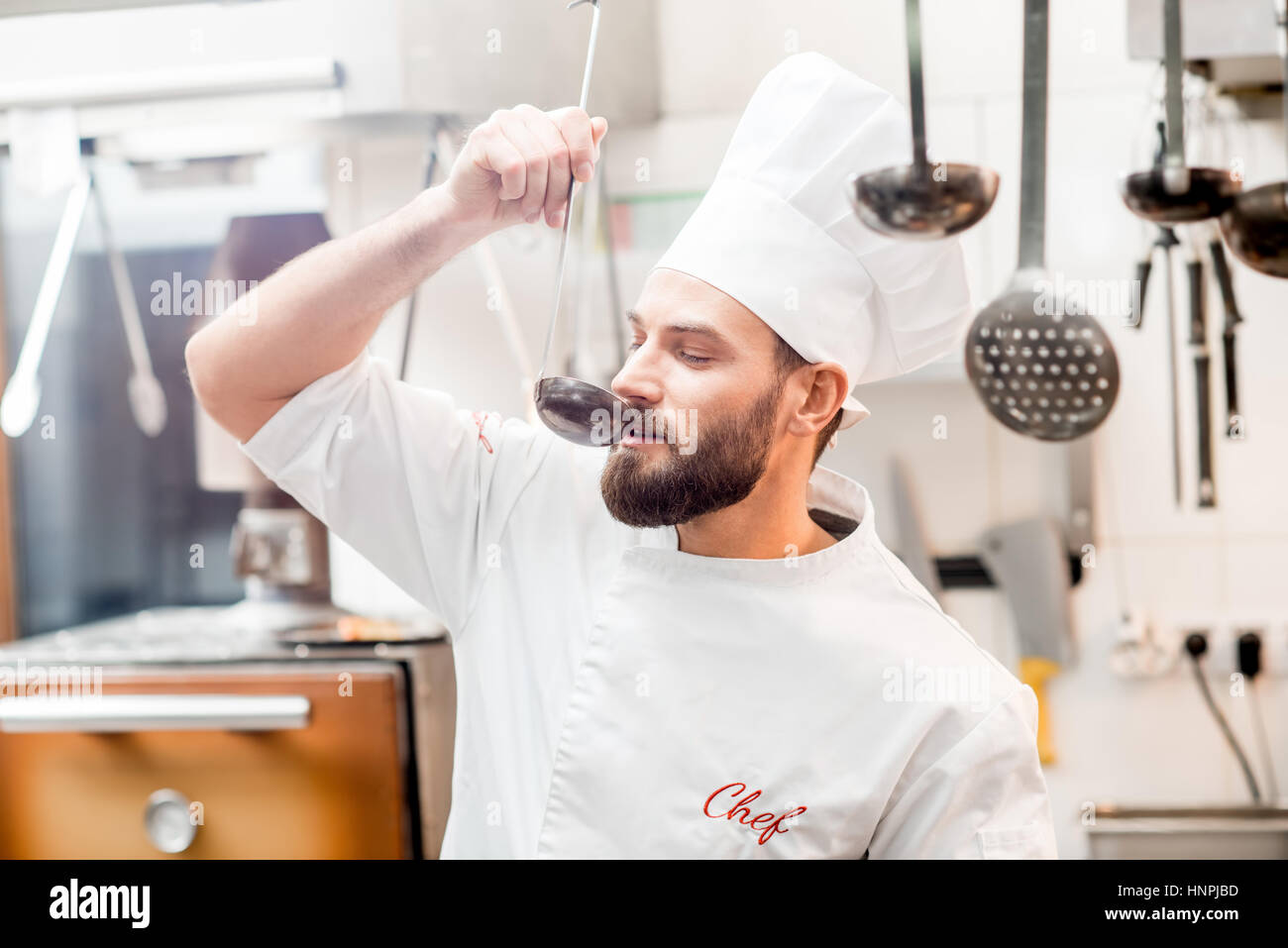Chef cook tasting food with big scoop at the restaurant kitchen Stock ...