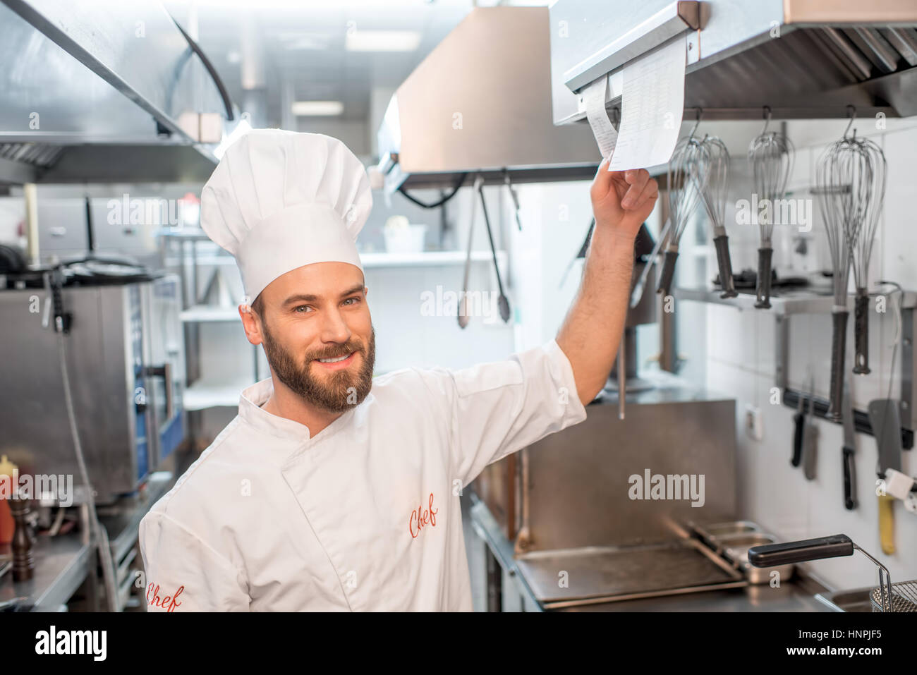 Chef cook checking the order at the restaurant kitchen Stock Photo - Alamy