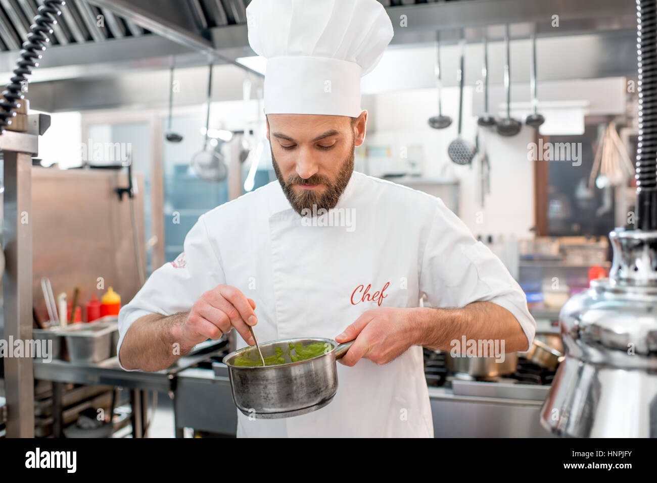 Handsome chef cook making sause at the restaurant kitchen Stock Photo ...