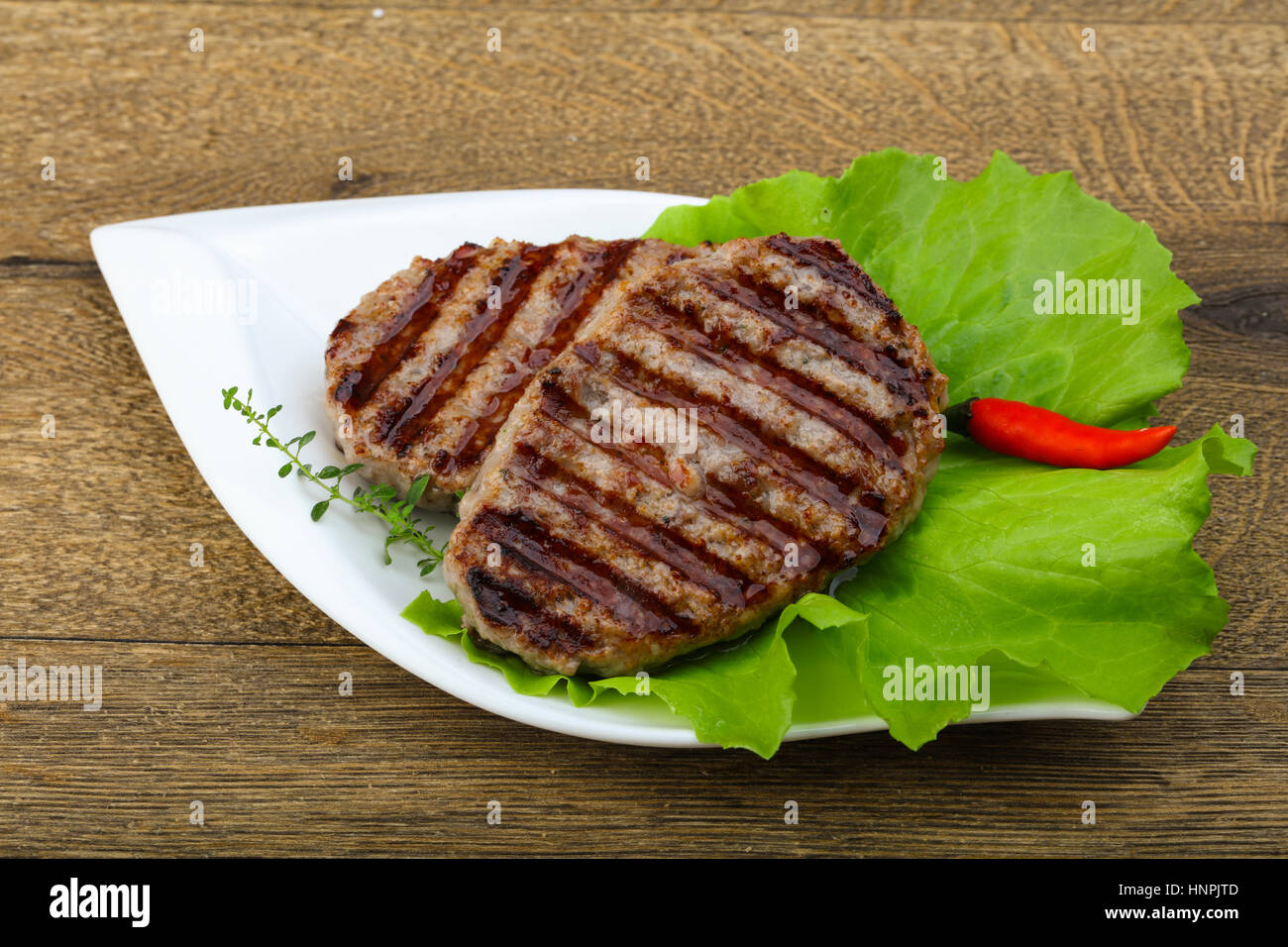 Grilled burget cutlet with pepper and salad leaes Stock Photo - Alamy