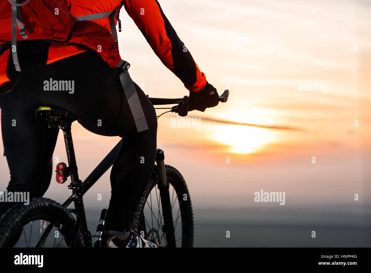 Man on mountain bike rides on the trail on a beautiful sunset. Bicycle ...