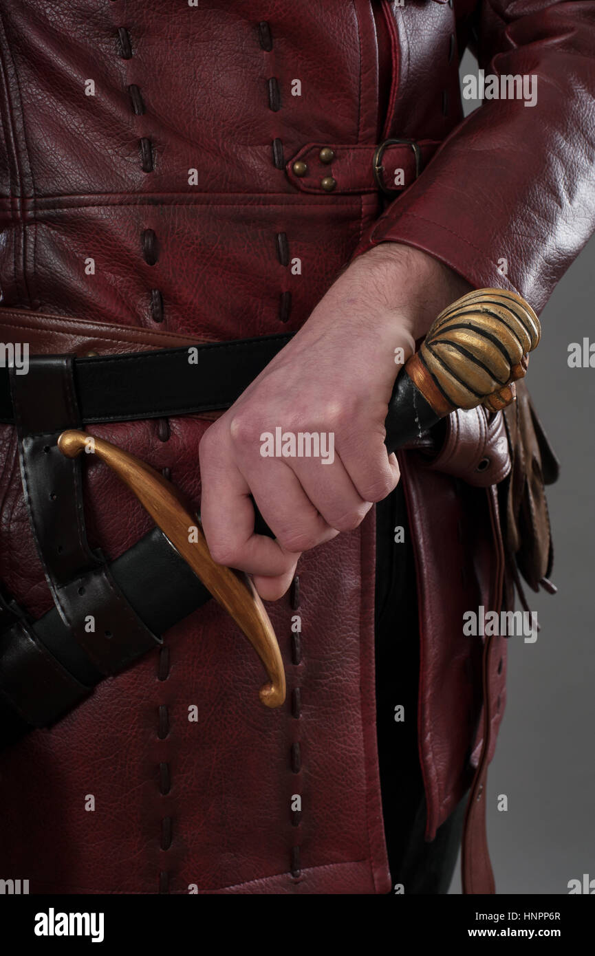 Medieval knight holding hand on his sword. Closeup. Studio shoot Stock ...
