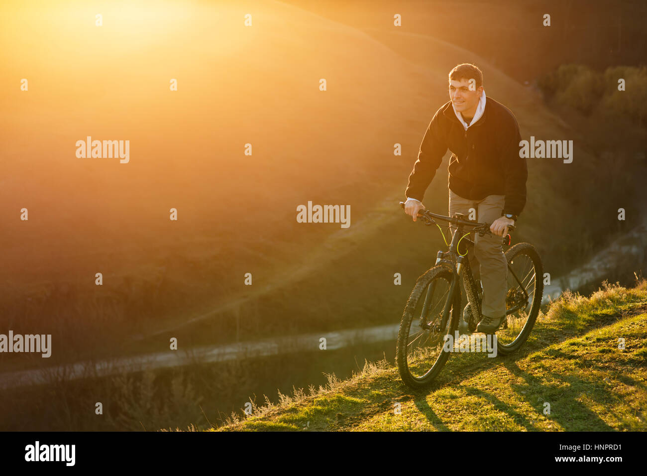 Mountain biker riding on bike in spring inspirational mountains ...
