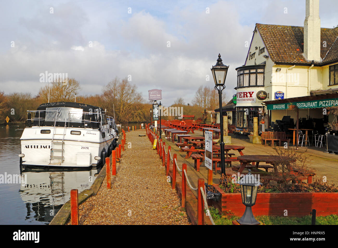 A cruiser moored outside the Ferry Inn on the Norfolk Broads at Horning ...
