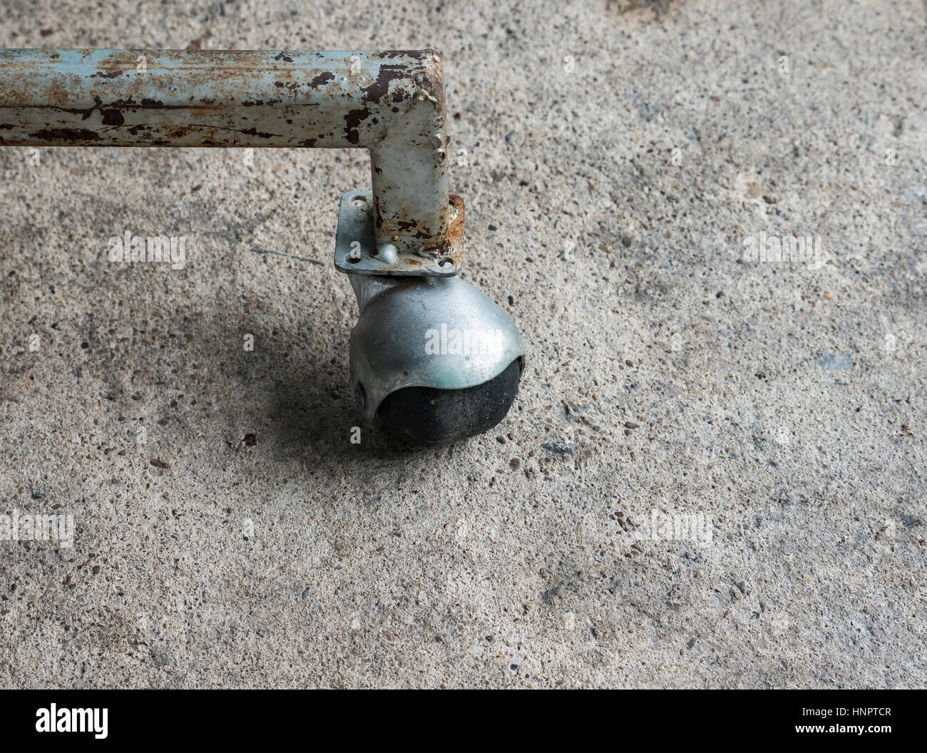 Black rubber wheel of the old metal wash line on the cement floor Stock ...