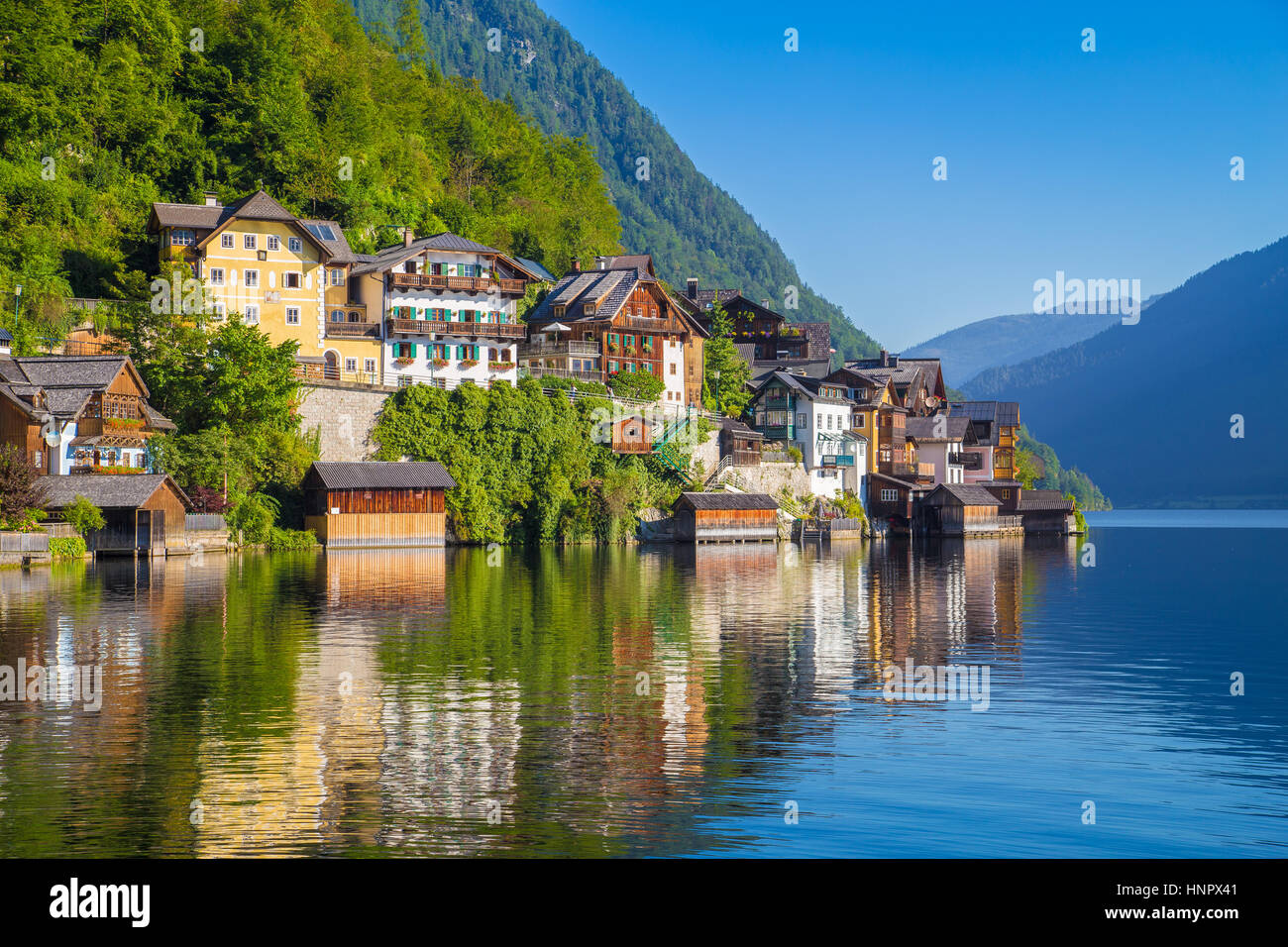 Scenic postcard view of traditional old wooden houses in famous Hallstatt lakeside town at ...