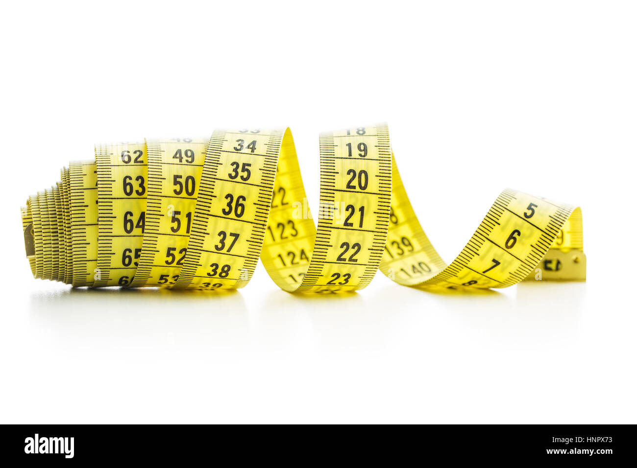 The yellow measuring tape isolated on white background Stock Photo - Alamy