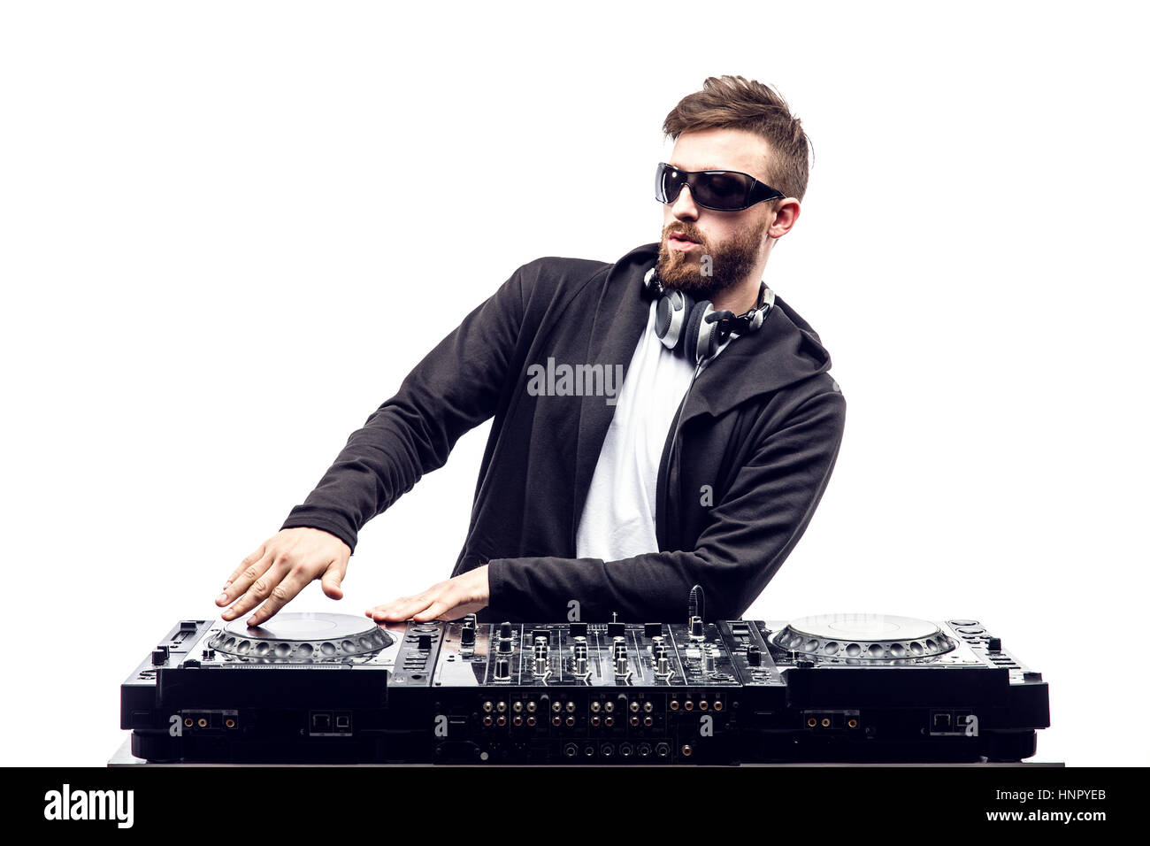 Trendy male dj posing against mixing console Stock Photo - Alamy