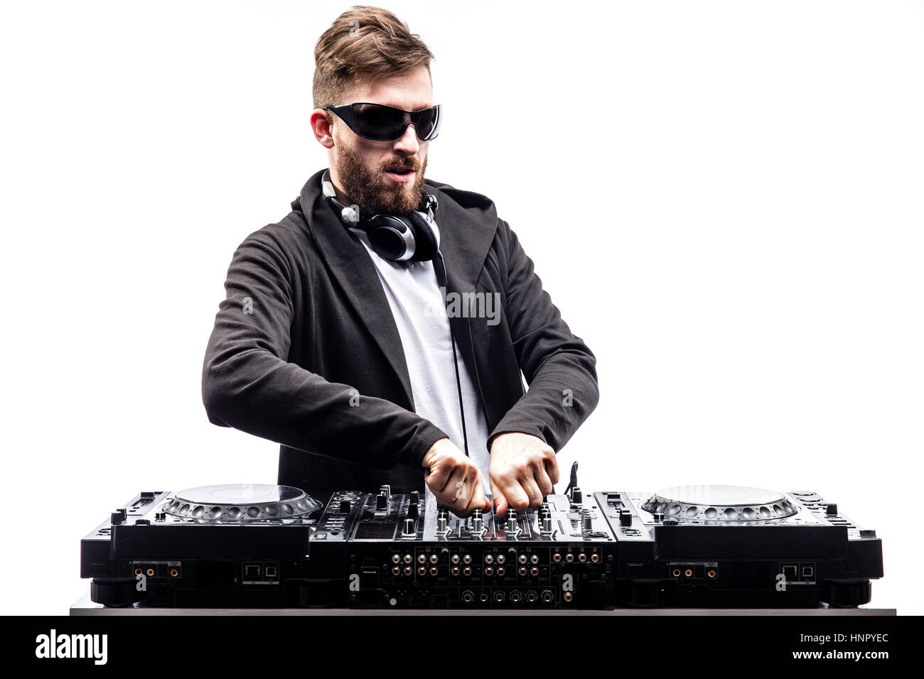 Trendy male dj posing against mixing console Stock Photo - Alamy