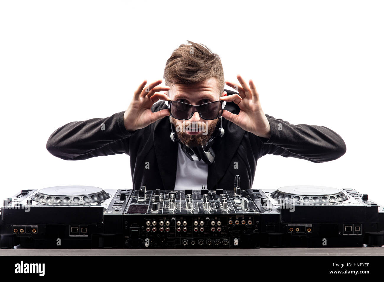 Trendy male dj posing against mixing console Stock Photo - Alamy