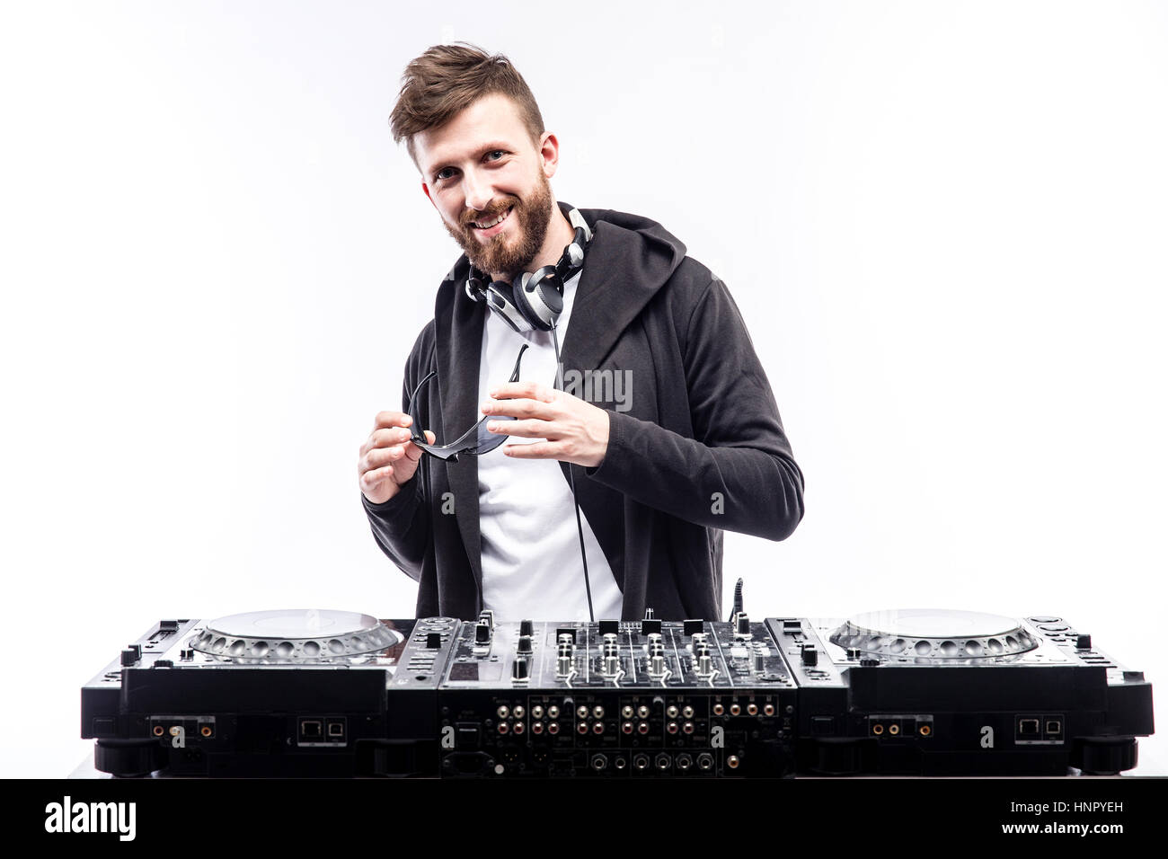 Trendy male dj posing against mixing console Stock Photo - Alamy