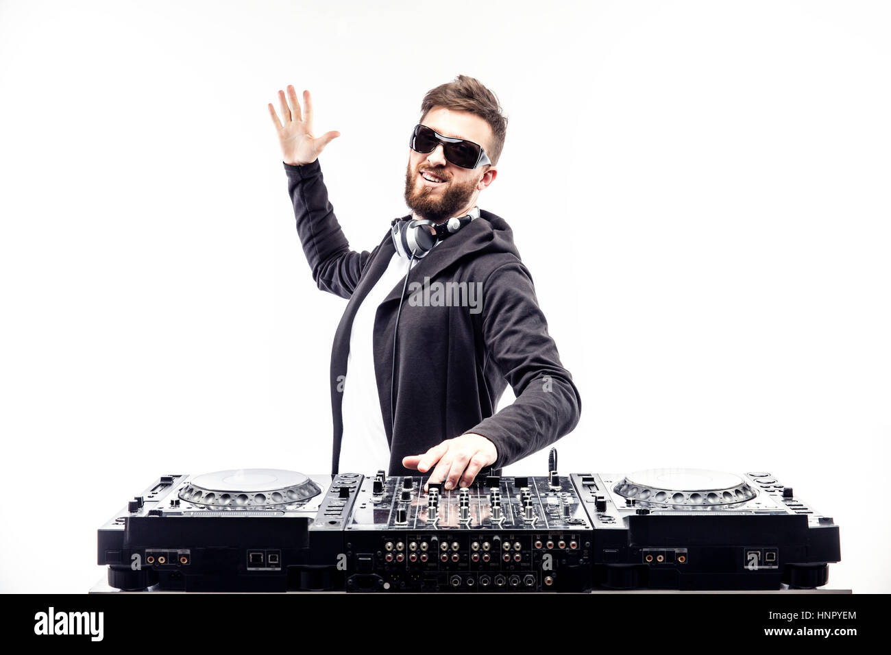 Trendy male dj posing against mixing console Stock Photo - Alamy