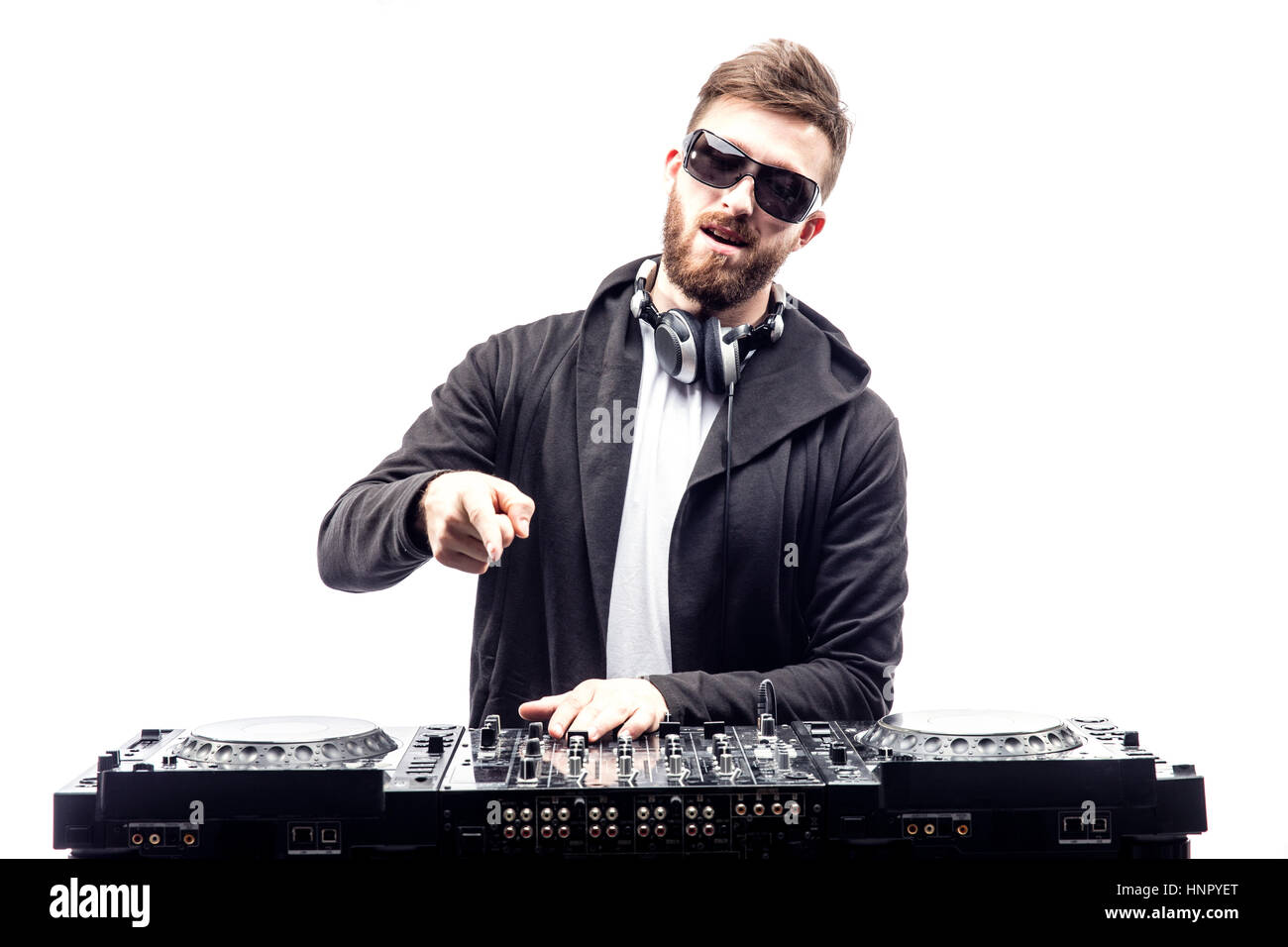 Trendy male dj posing against mixing console Stock Photo - Alamy