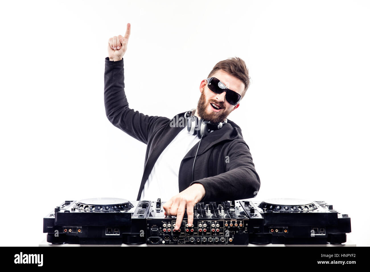 Trendy male dj posing against mixing console Stock Photo - Alamy