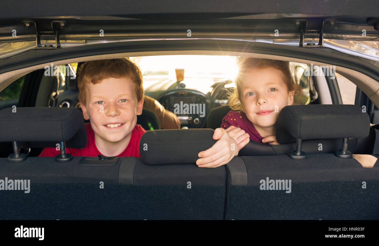 Children looking through the hatchback opening in a car Stock Photo - Alamy