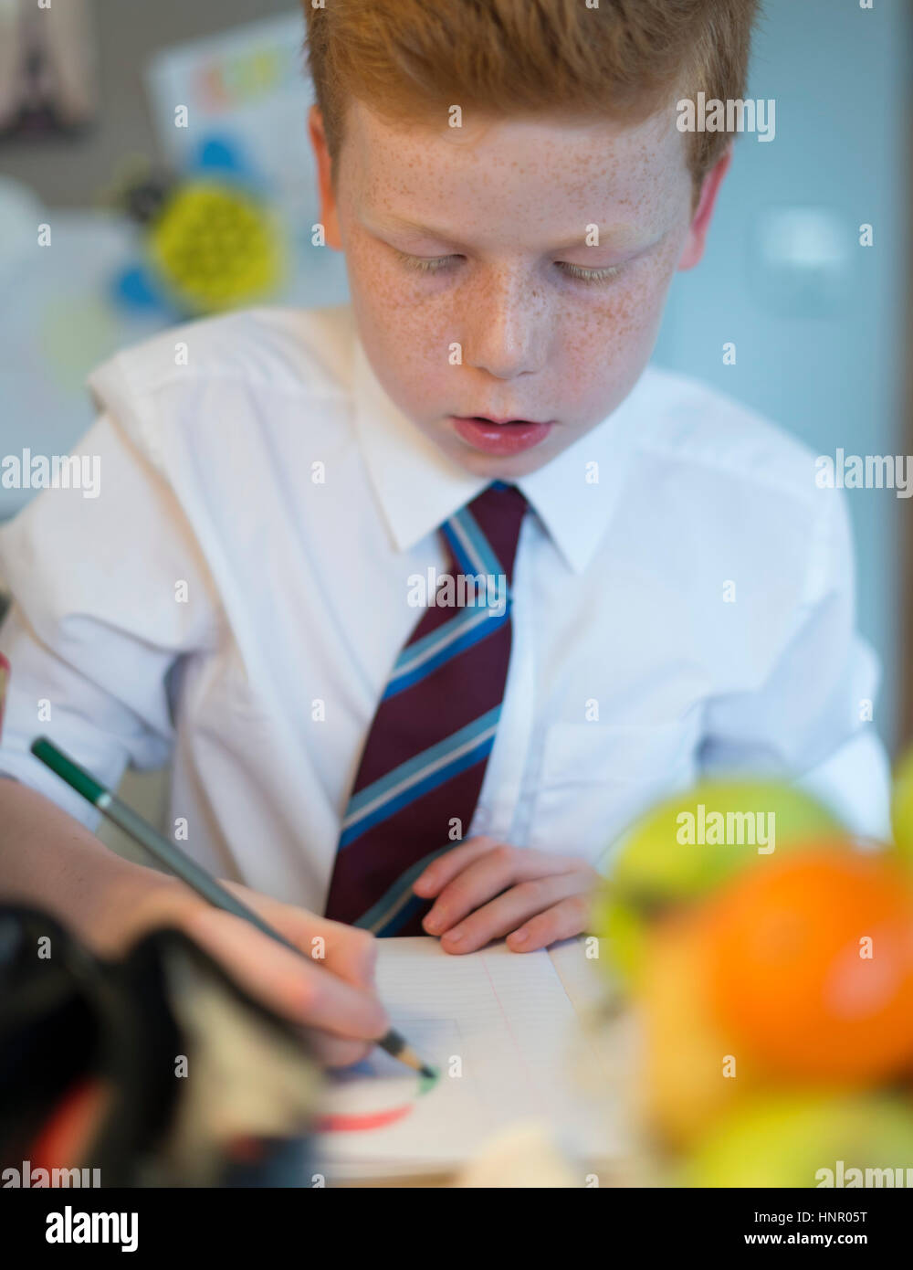 A boy drawing for homework in his kitchen at home Stock Photo - Alamy