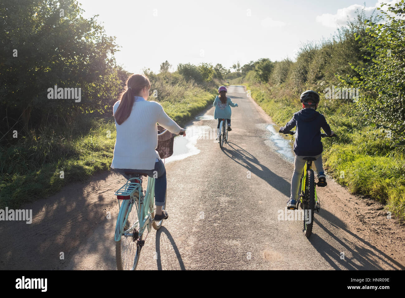 A family bike ride with mother and two children in the countryside ...