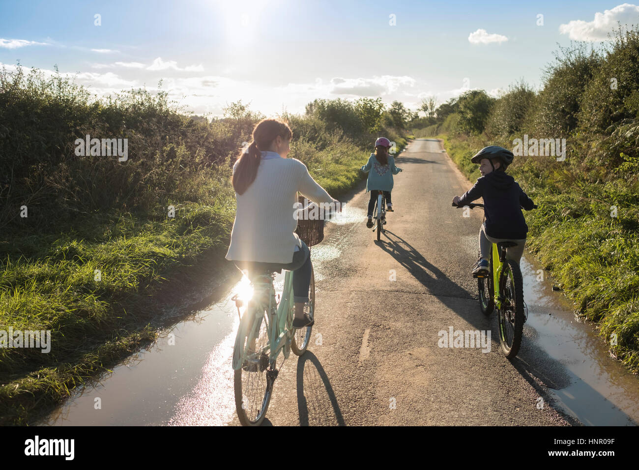A family bike ride with mother and two children in the countryside ...