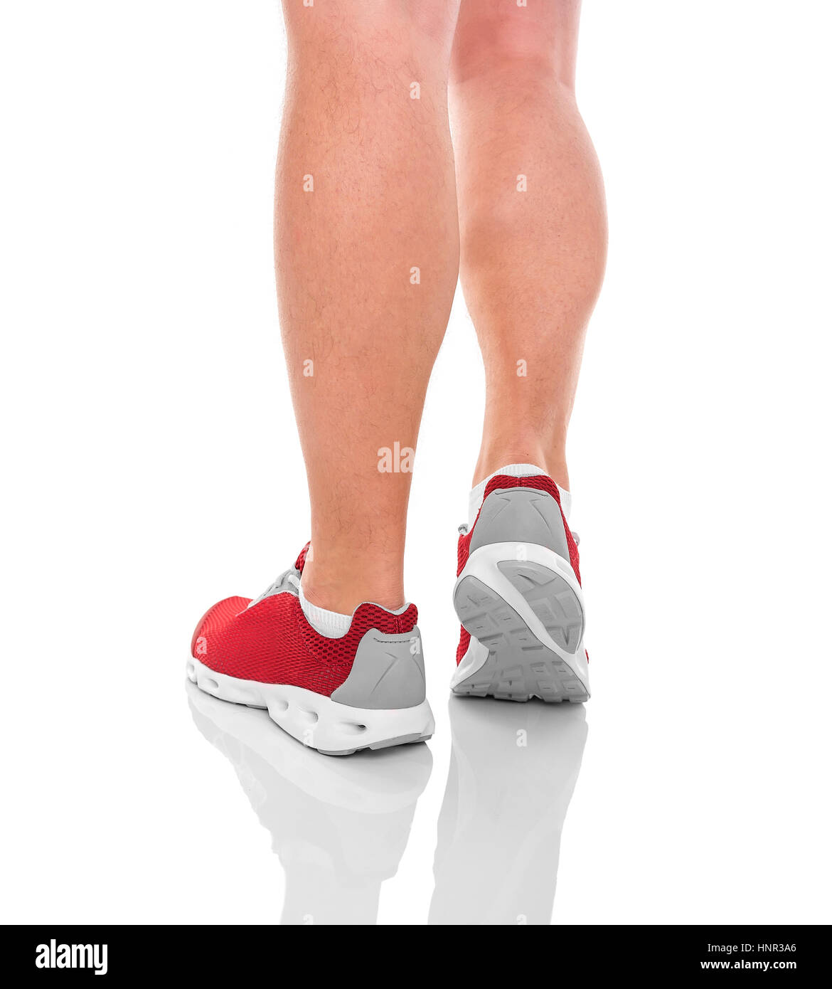 Men's sports legs in sneakers Stock Photo - Alamy