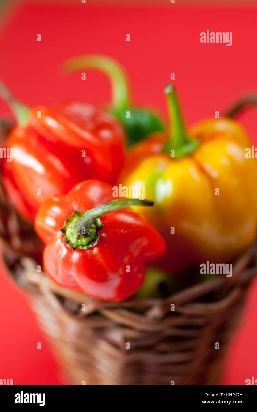 Small basket filled with mini hot peppers Stock Photo - Alamy