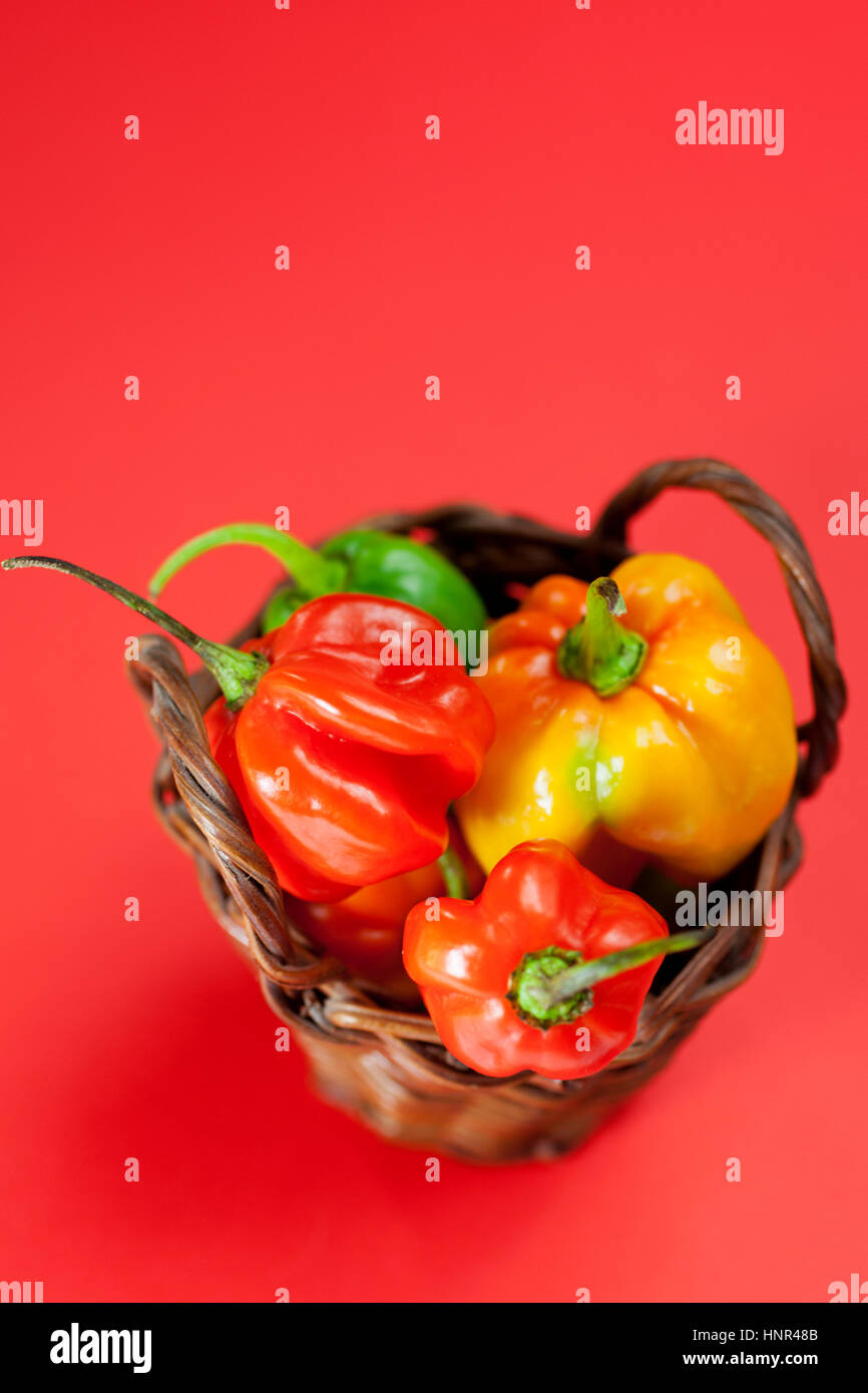 Small basket filled with mini hot peppers Stock Photo - Alamy