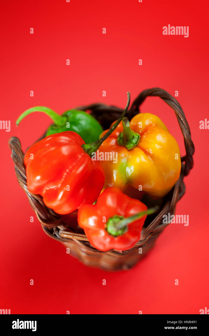 Small basket filled with mini hot peppers Stock Photo - Alamy