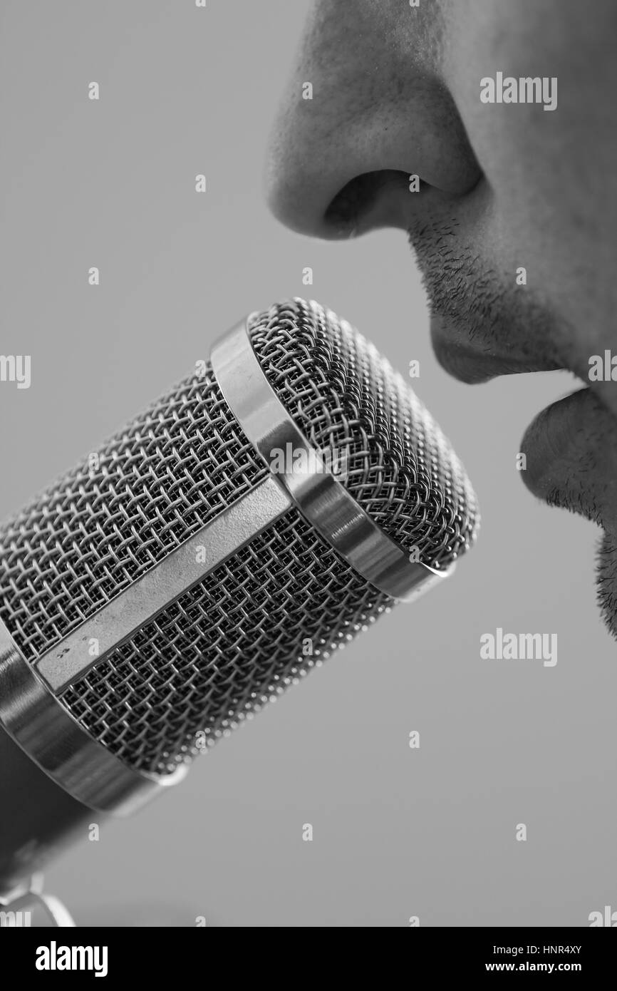 Singer Singing into microphone Stock Photo - Alamy