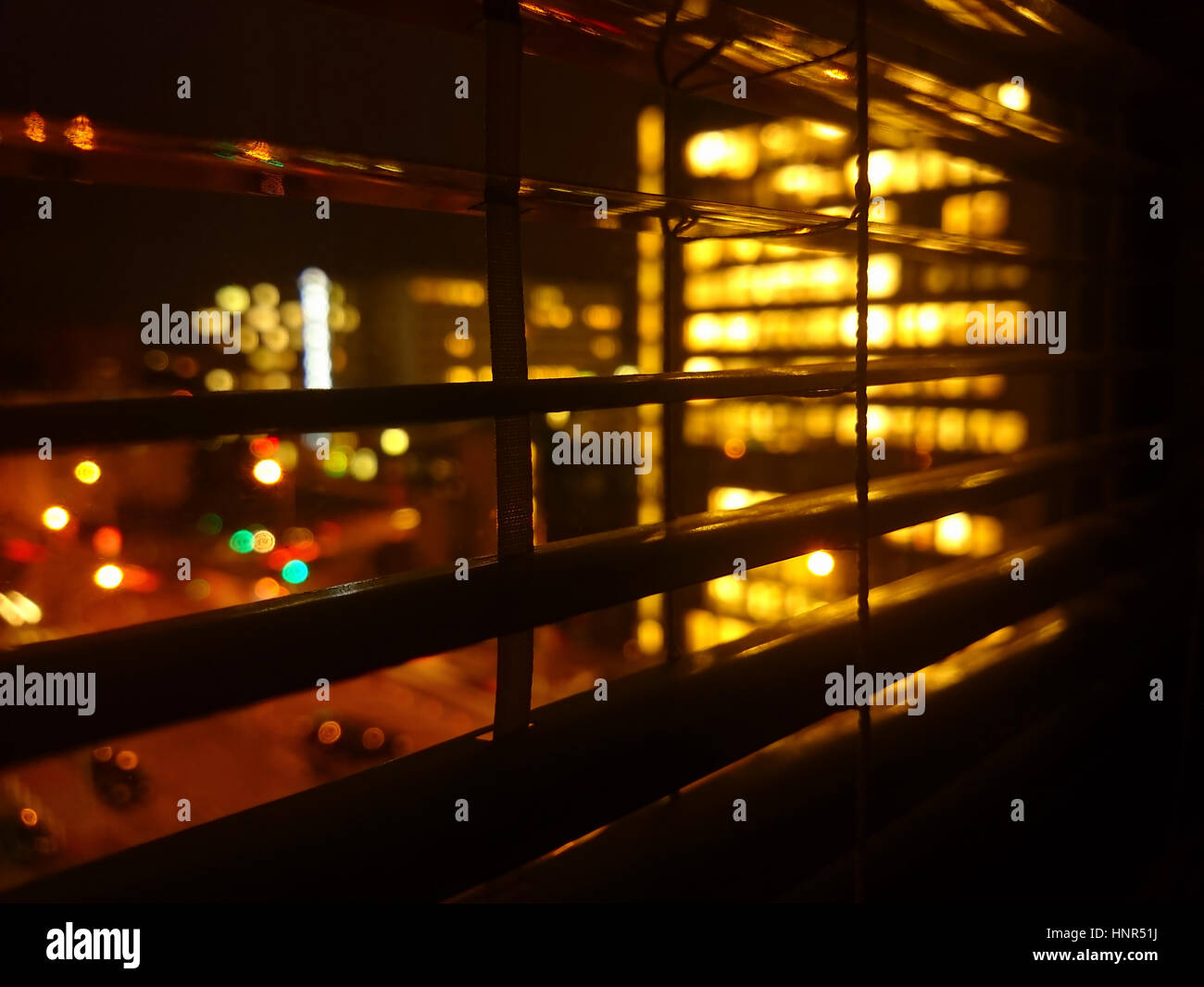 Closeup of shutter at night in office building with view to lighten ...