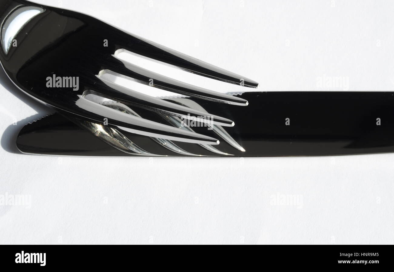 Knife and fork reflection on white background Stock Photo - Alamy