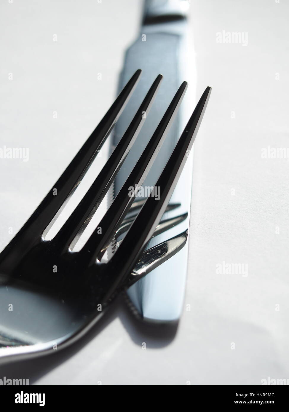 Knife and fork reflection on white background Stock Photo - Alamy