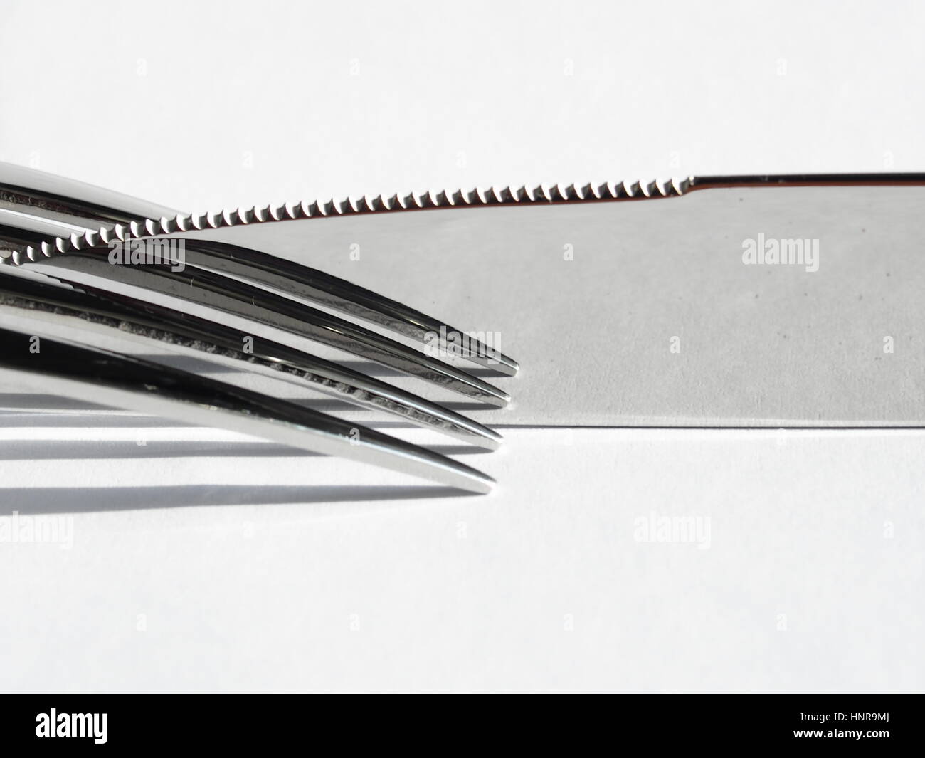 Knife and fork reflection on white background Stock Photo - Alamy