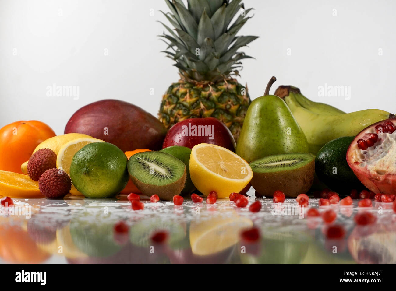 Juicy tropical fruits with water drops on a white surface. Great ...