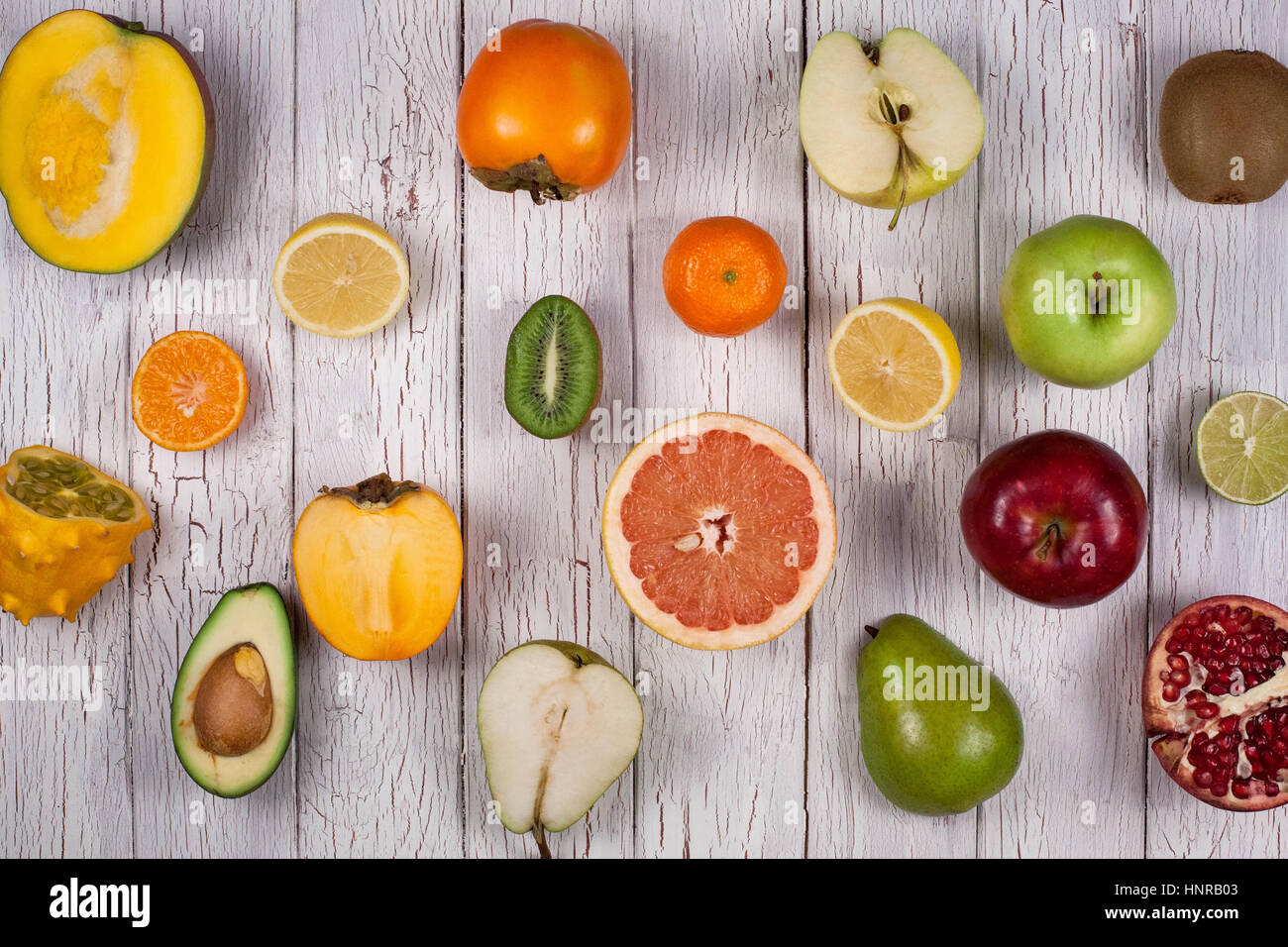 Studio shot of tropical fruits on a white wooden board in a ...