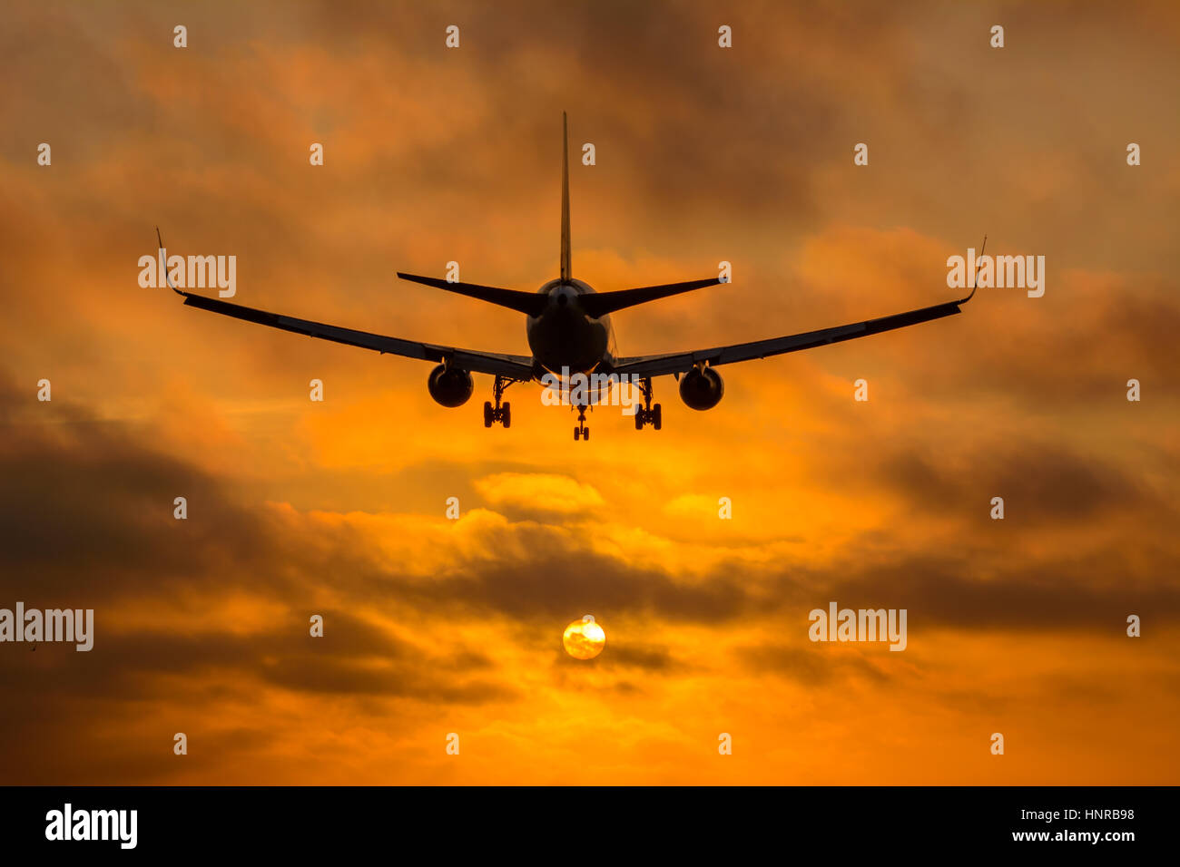 Airplane landing during sunrise photo hi-res stock photography and ...